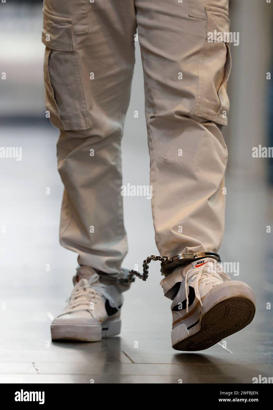 30 January 2024, Bavaria, Würzburg: The defendant is brought to the ...