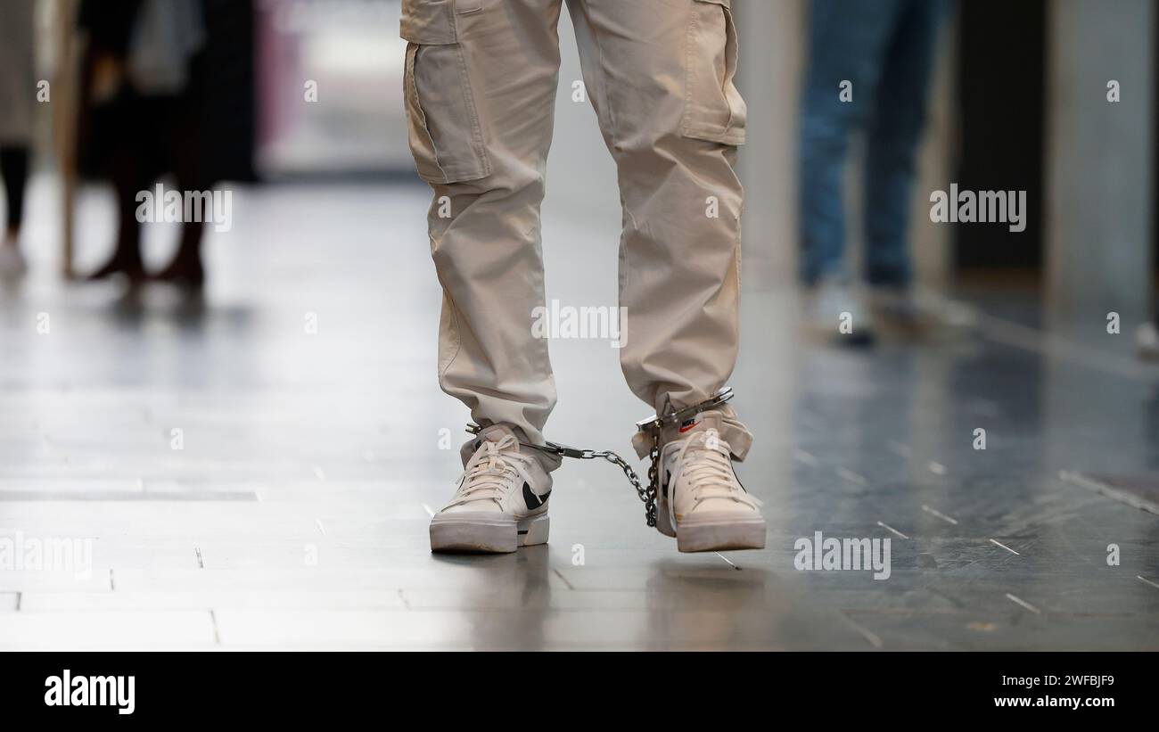 30 January 2024, Bavaria, Würzburg: The defendant is brought to the ...