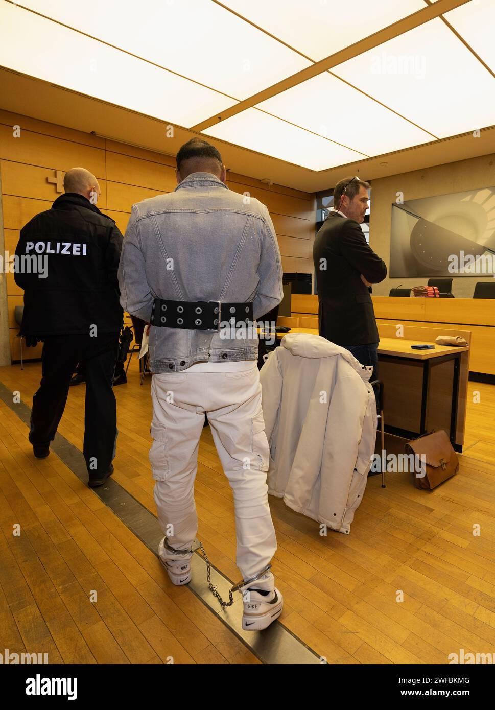 30 January 2024, Bavaria, Würzburg: The defendant (M) is brought to the ...