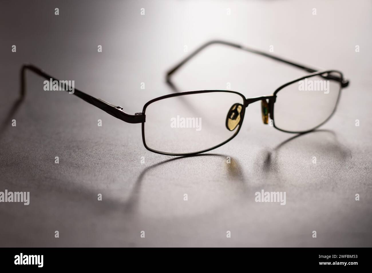 Eye Glasses with shadow on gray background Stock Photo - Alamy