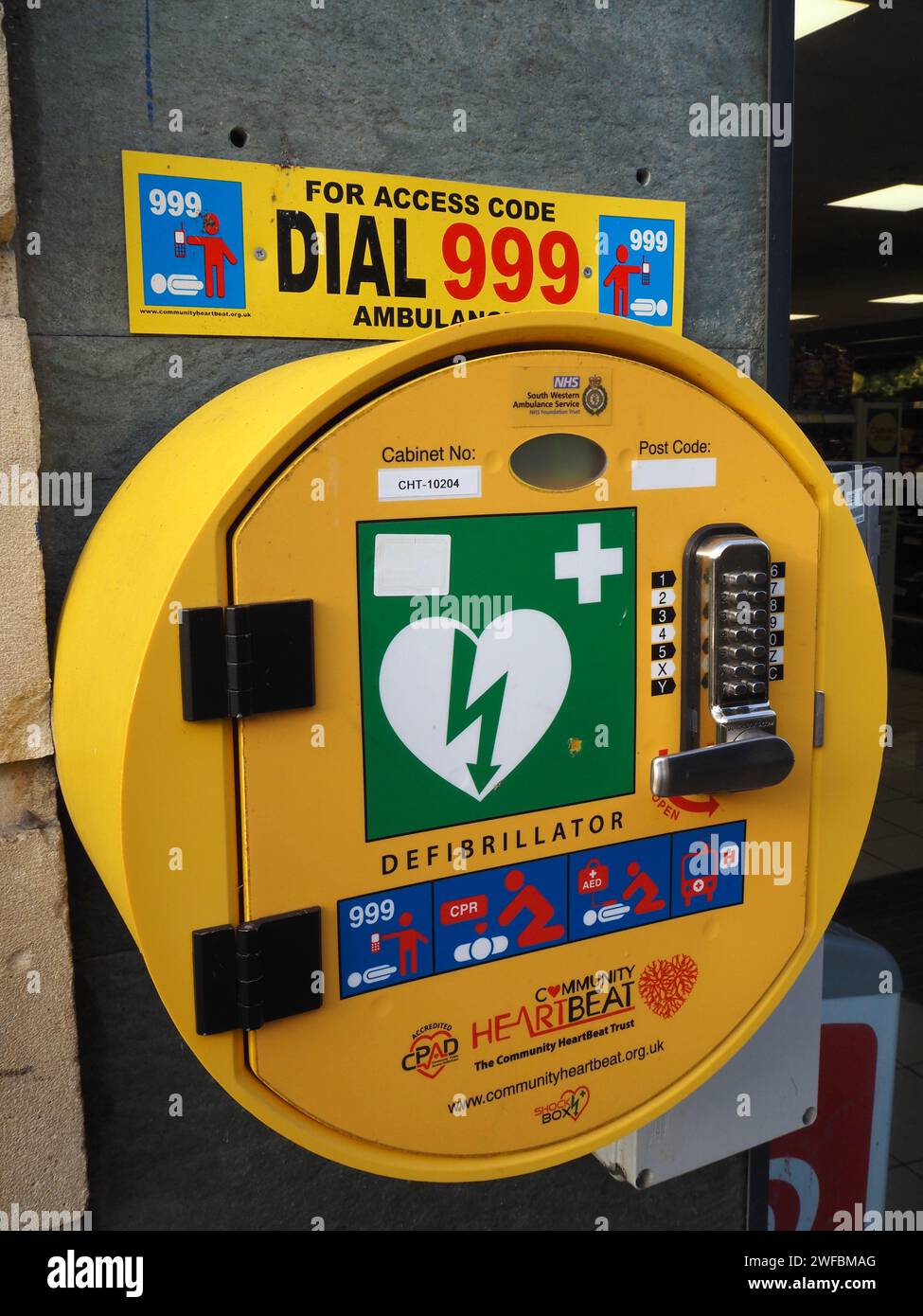Yellow defibrillator cabinet with digicode access for medical emergency ...