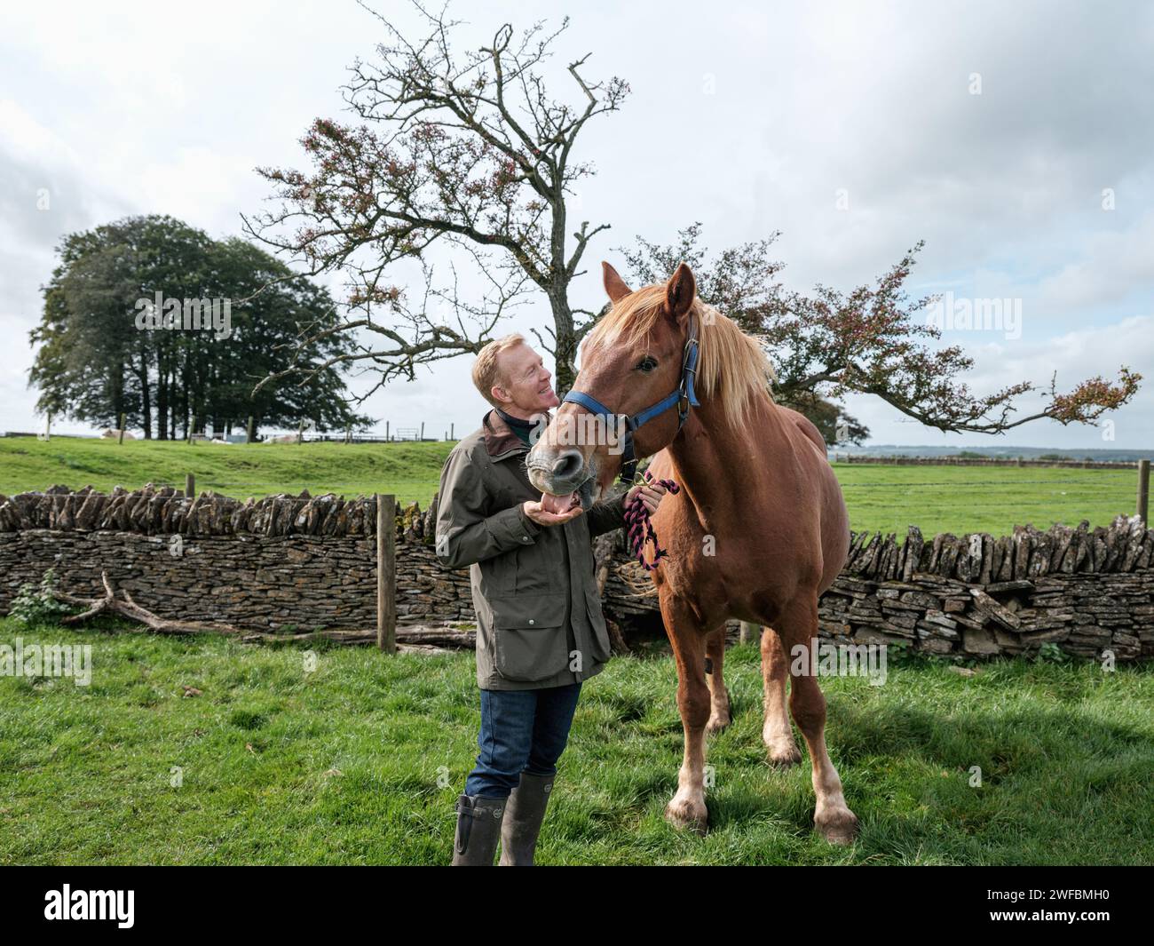 Adam Henson on his farm with one of his horses Stock Photo - Alamy