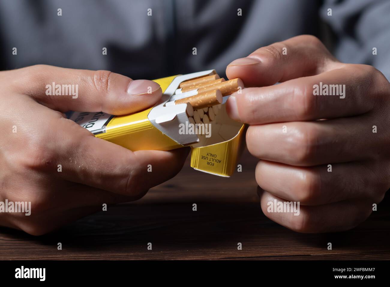 close up man hand holding peel it off cigarette pack prepare smoking a ...