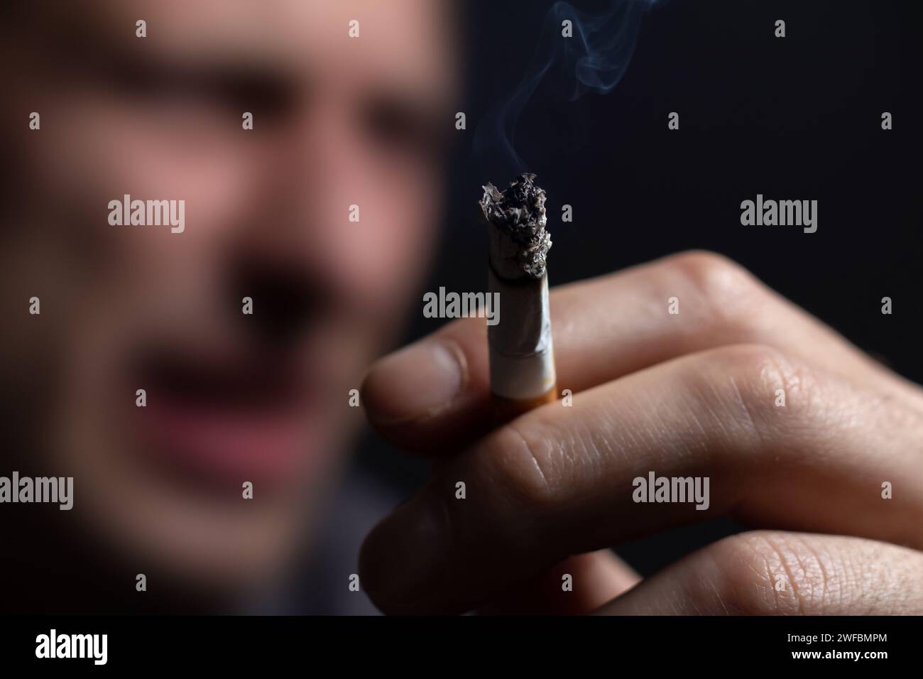 Passive smoking concept. Man is smoking cigarette and other man ...