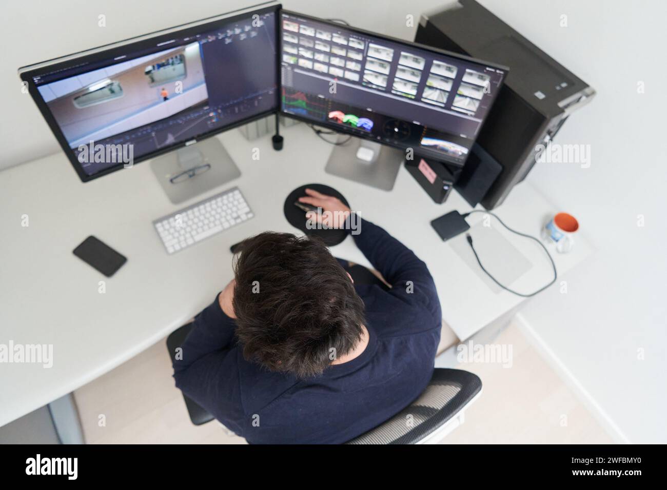 professional video editor enhancing digital footage using specialized software Stock Photo - Alamy