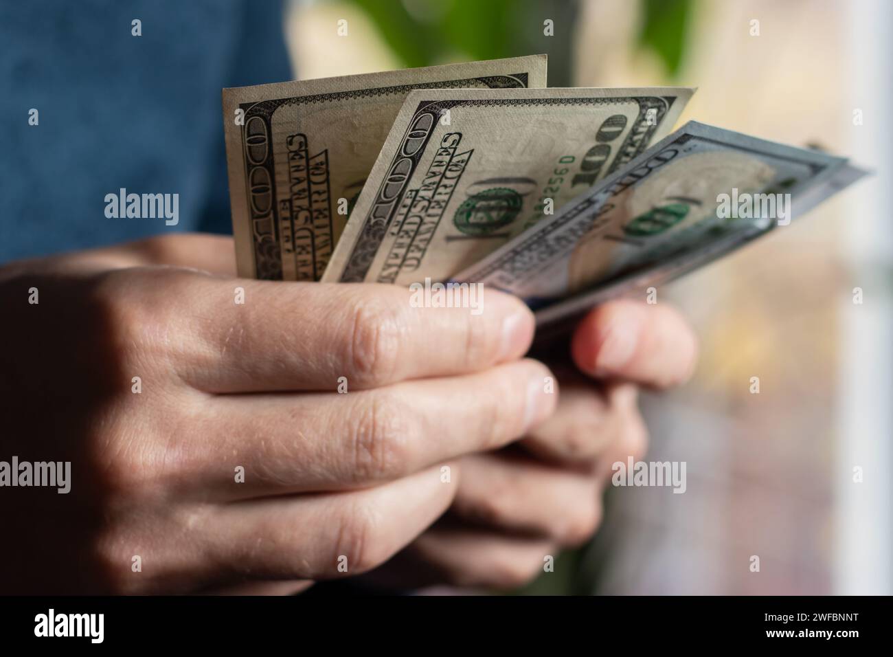 100 dollar banknotes counting hand hi-res stock photography and images ...