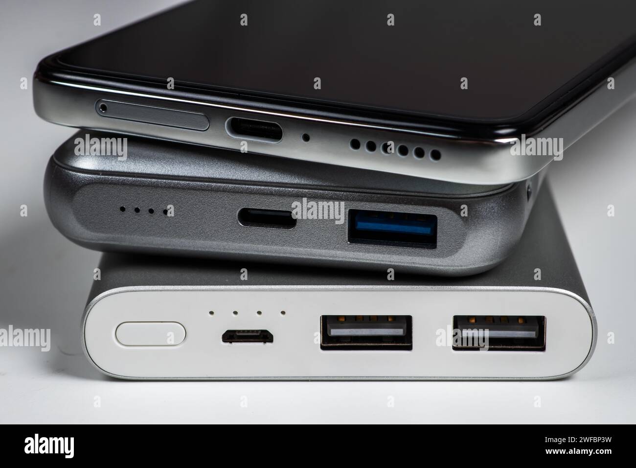 Two powerbank and smartphone on white background Stock Photo - Alamy