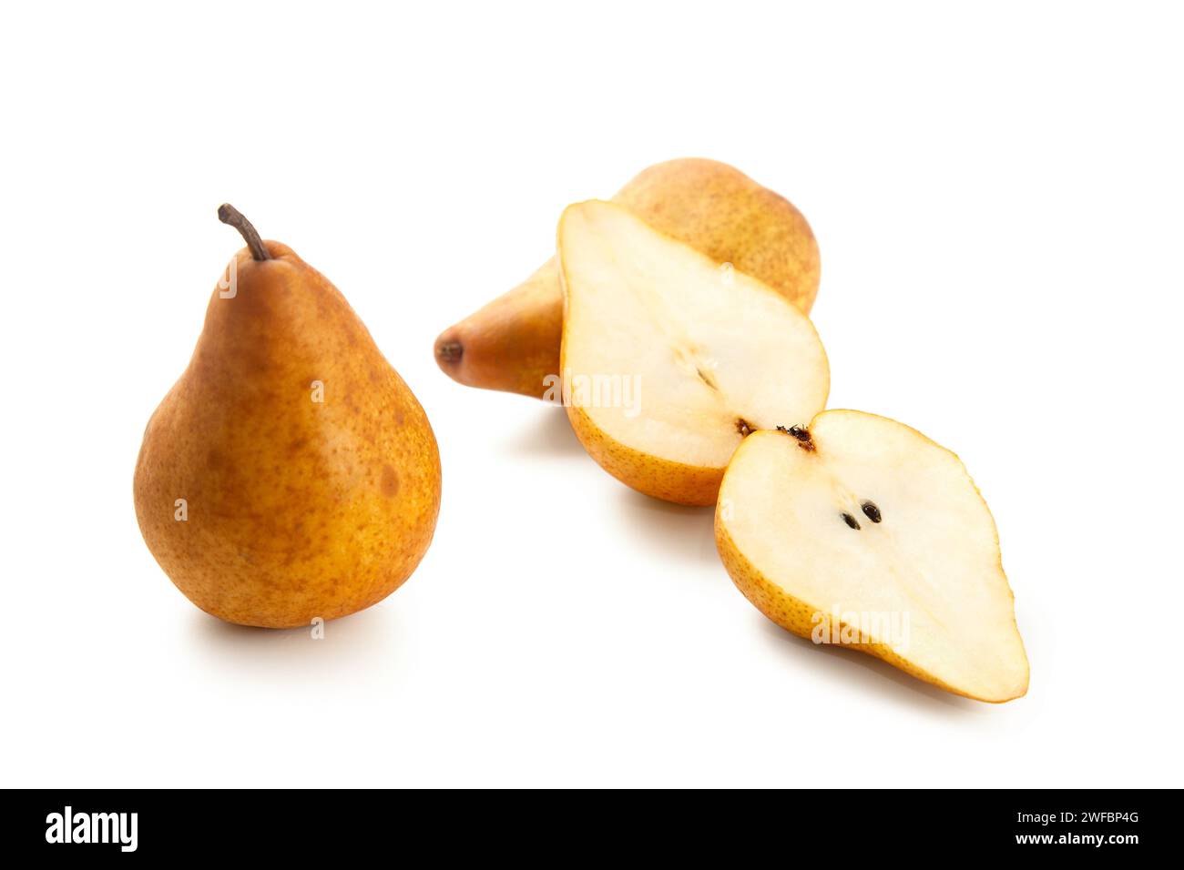 Two whole and halves of ripe juicy pear fruits with soft shadow ...