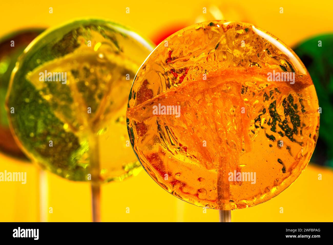 Lollipops with dry fruits inside on a yellow background. Healthy ...