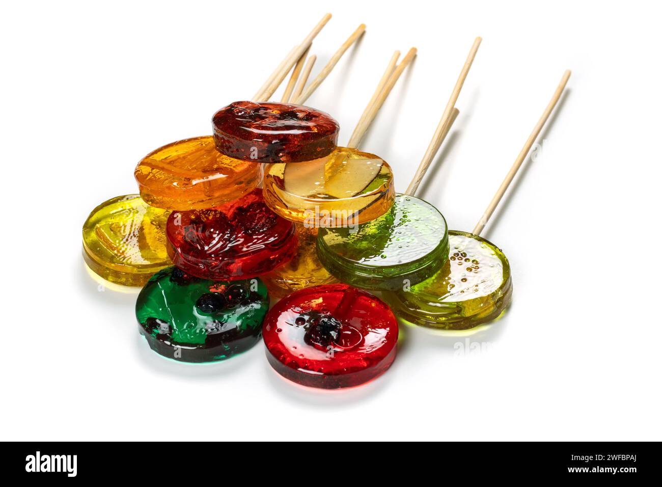 Sweet colorful lollipops with dried fruits on white background Stock ...
