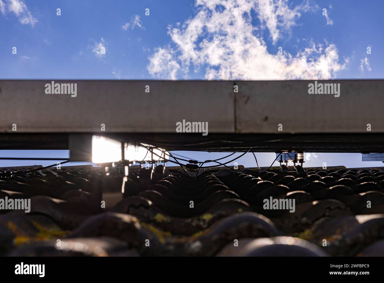 View under a photovoltaic system with mounting and cable on a house ...