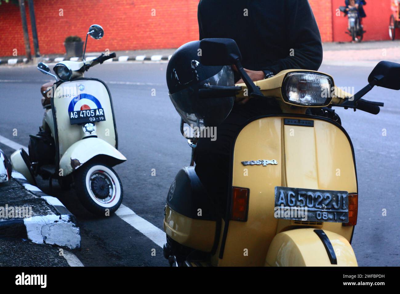 front view of classic scooter vespa parked in side of road Stock Photo ...