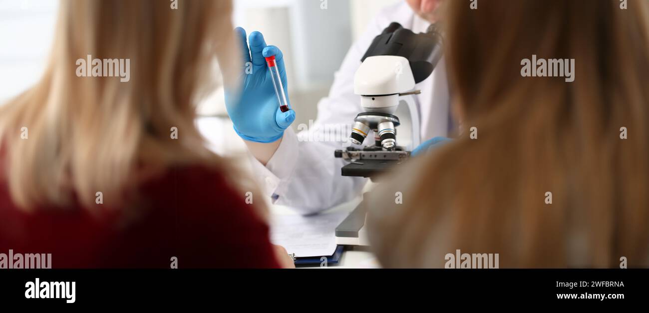 Doctor patient blood sample front microscope Stock Photo - Alamy