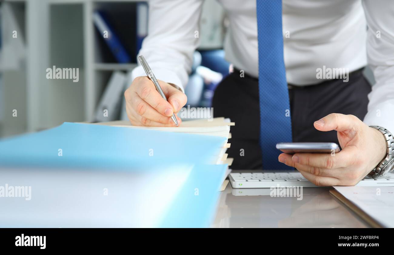 Businessman signs stack documents in table office Stock Photo - Alamy