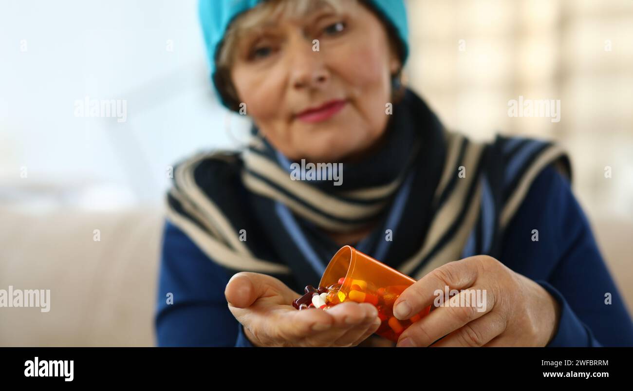 Cold elderly woman falls asleep on palm capsule Stock Photo - Alamy