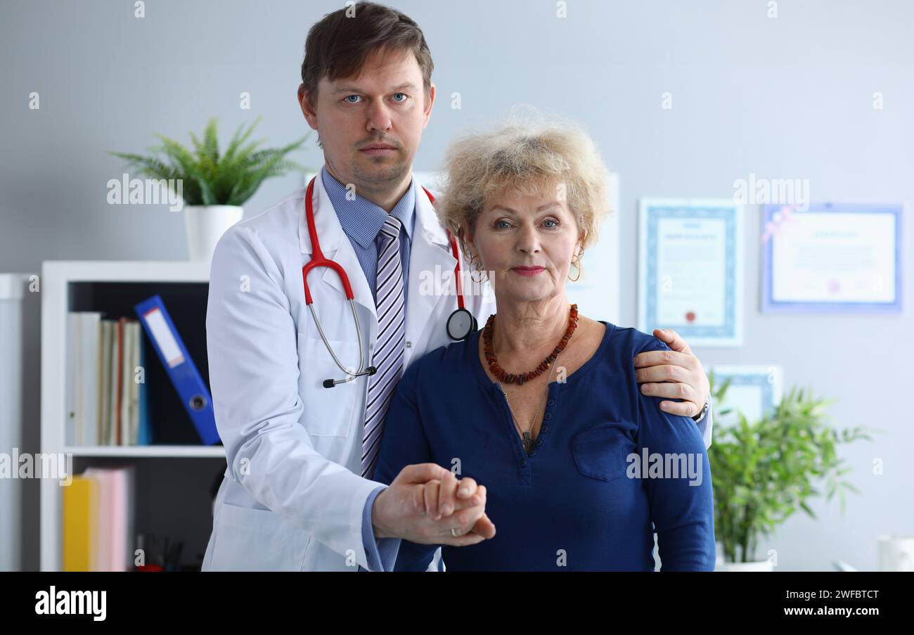 Doctor helps elderly woman to resist during illness Stock Photo - Alamy