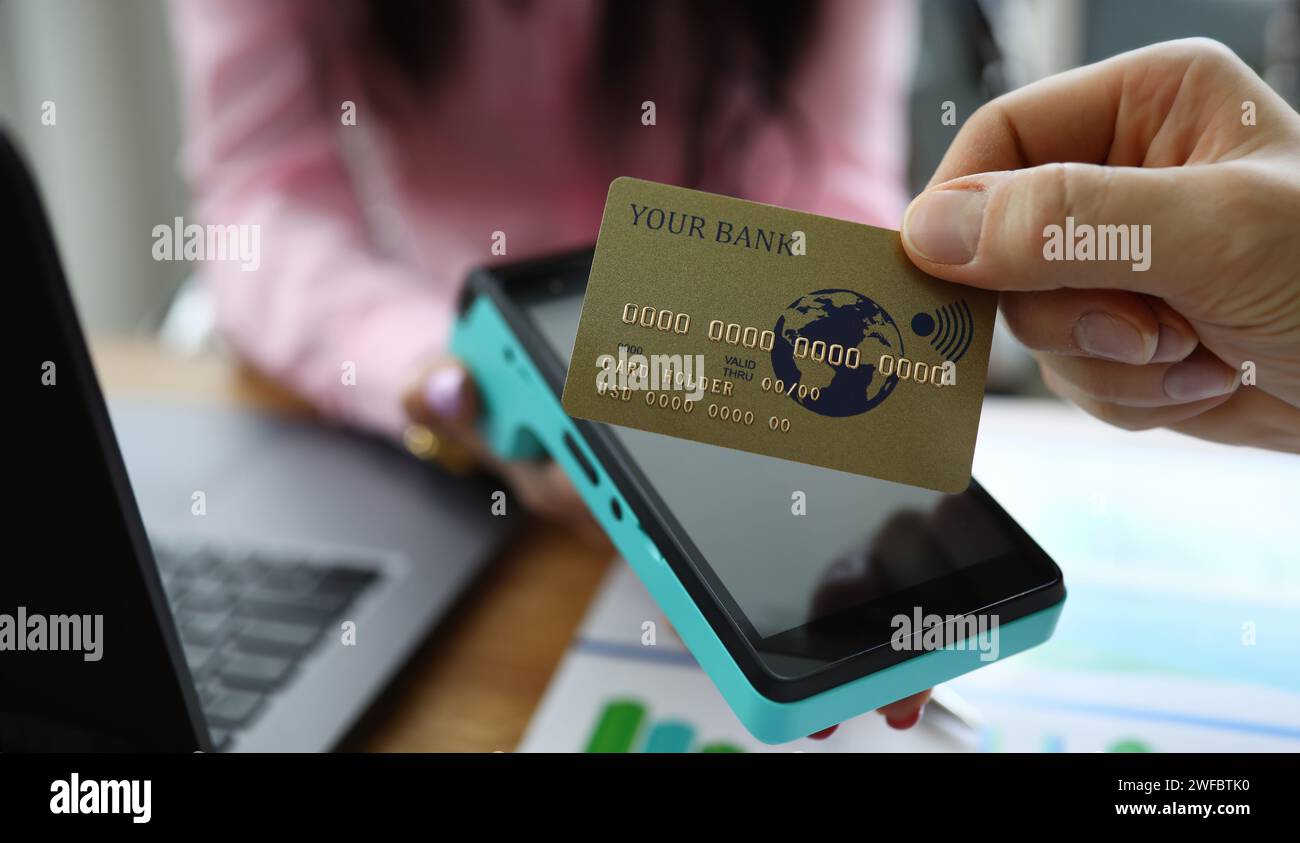 Male fingers hold credit card above terminal Stock Photo - Alamy