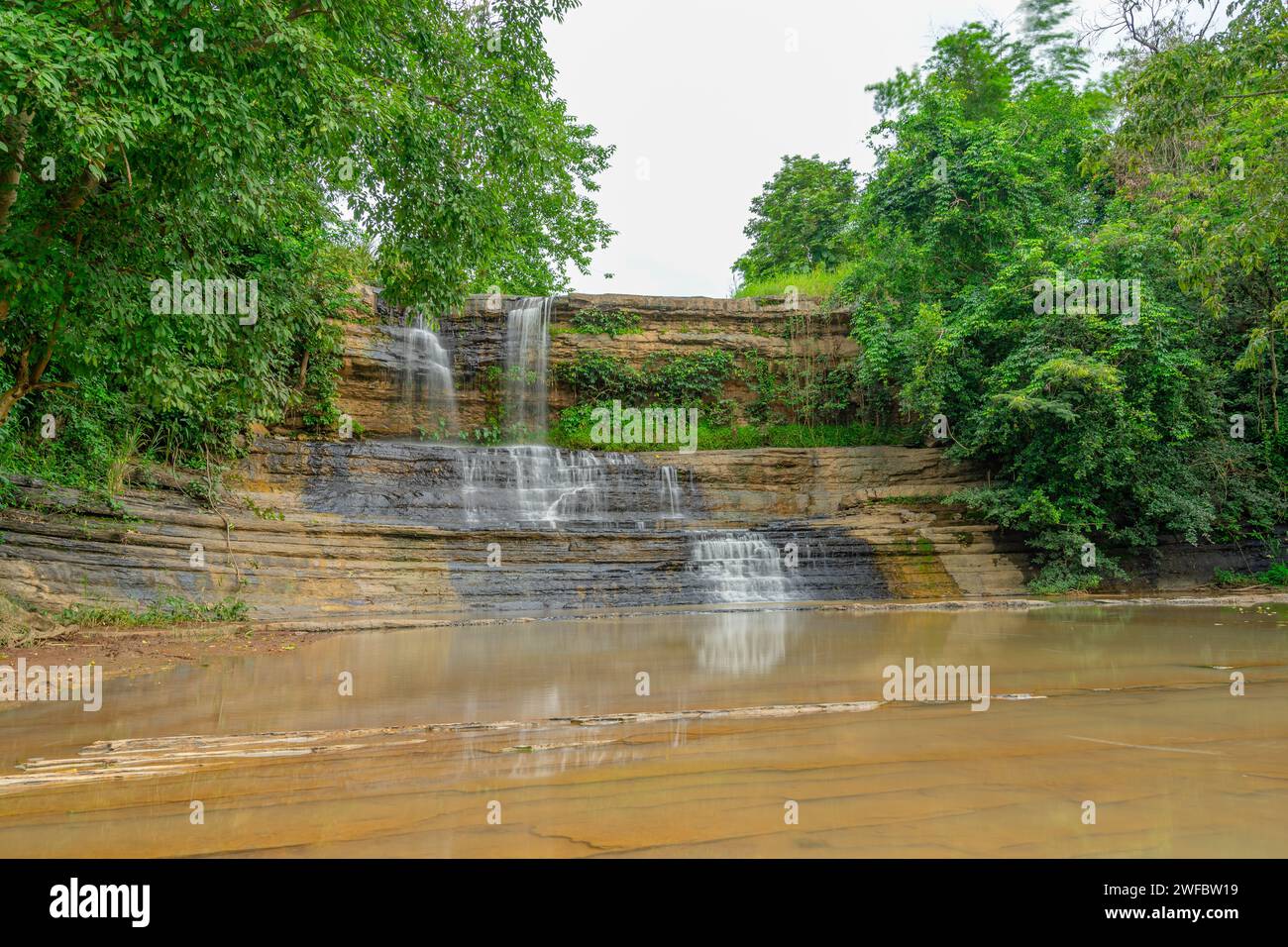 Waterfall called Thit Mi Waterfall with rock layer and green forest ...