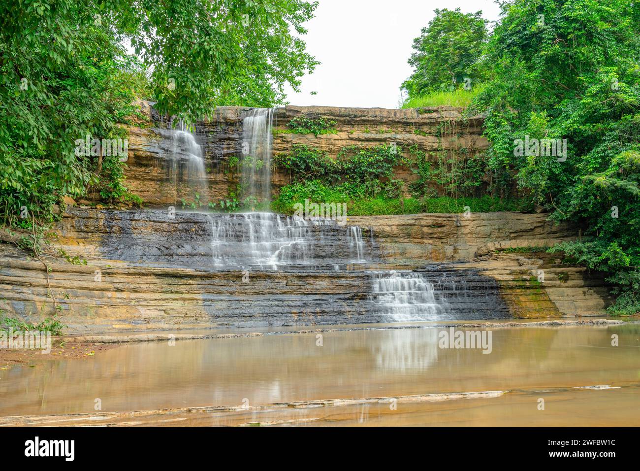 Waterfall called Thit Mi Waterfall with rock layer and green forest ...