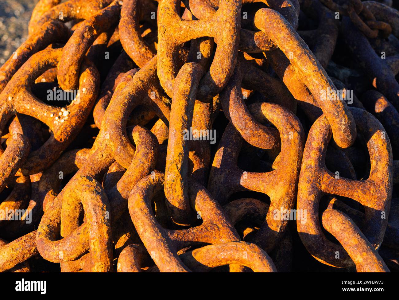 Rusty chains used by fishing boats for deploying nets sit on the ...