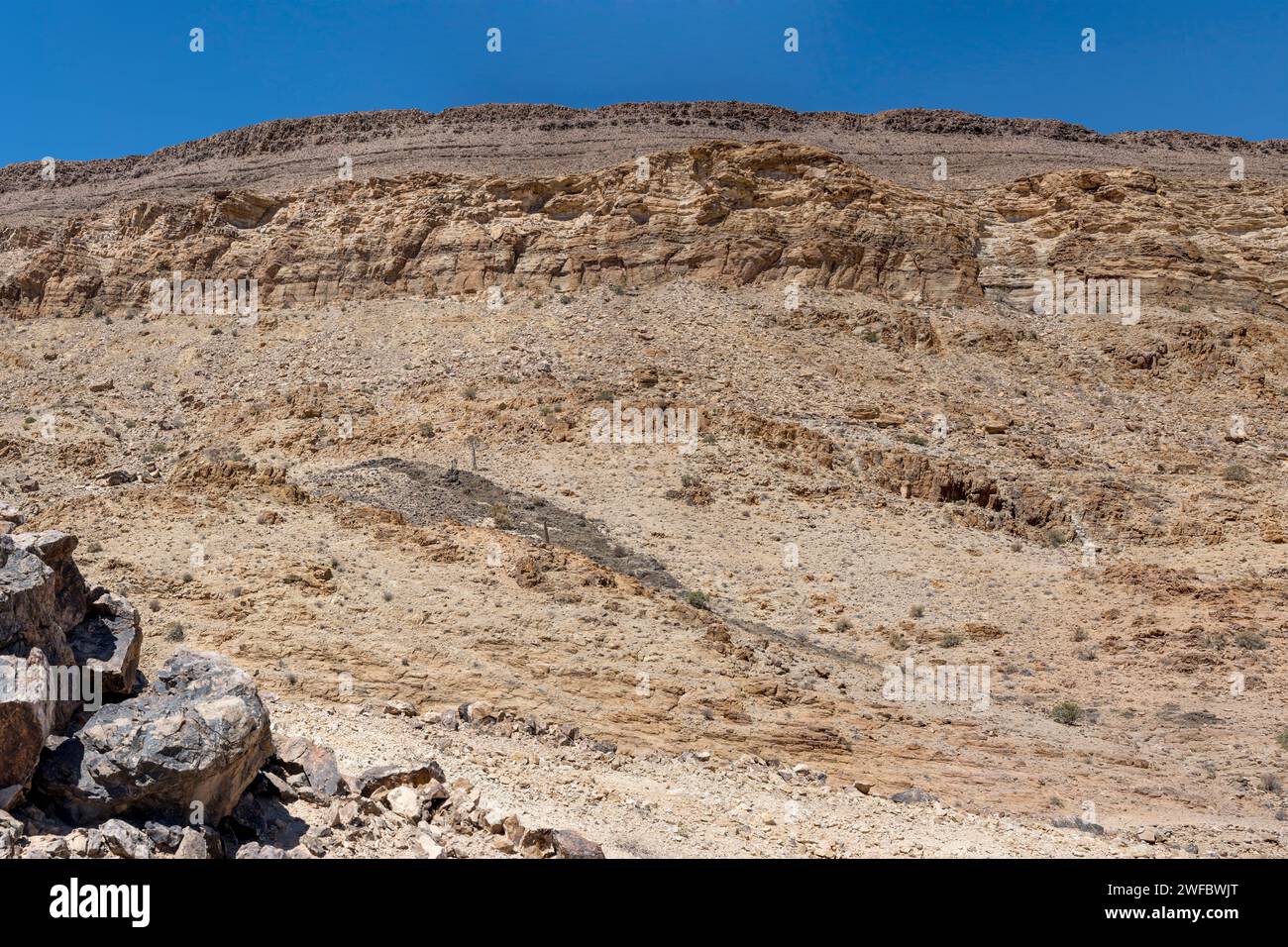 landscape with layers of conglomerate on steep hill slope in desert ...