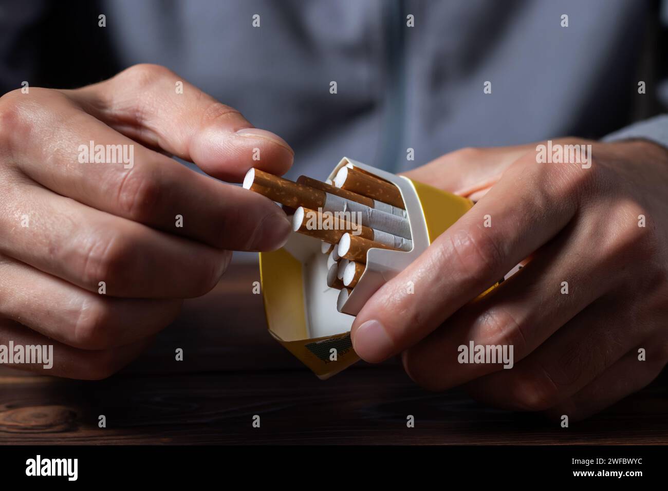 close up man hand holding peel it off cigarette pack prepare smoking a ...