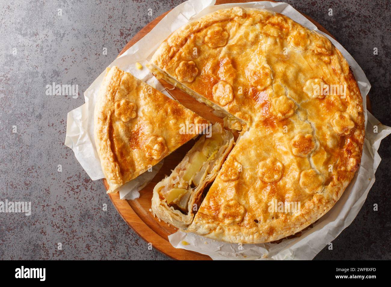 Layered Swiss pie with apple, potato, pear, onion and cheese close-up ...