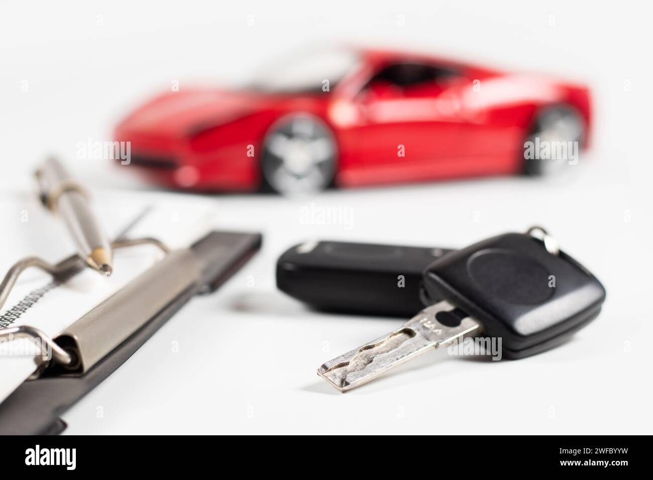 Car insurance form, pen and key on wooden table, and red car background ...