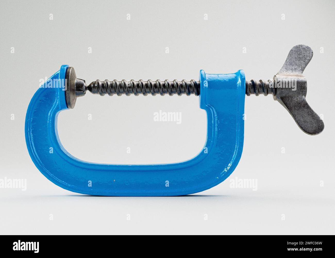 A blue vintage styled G-clamp tool on an isolated white studio ...