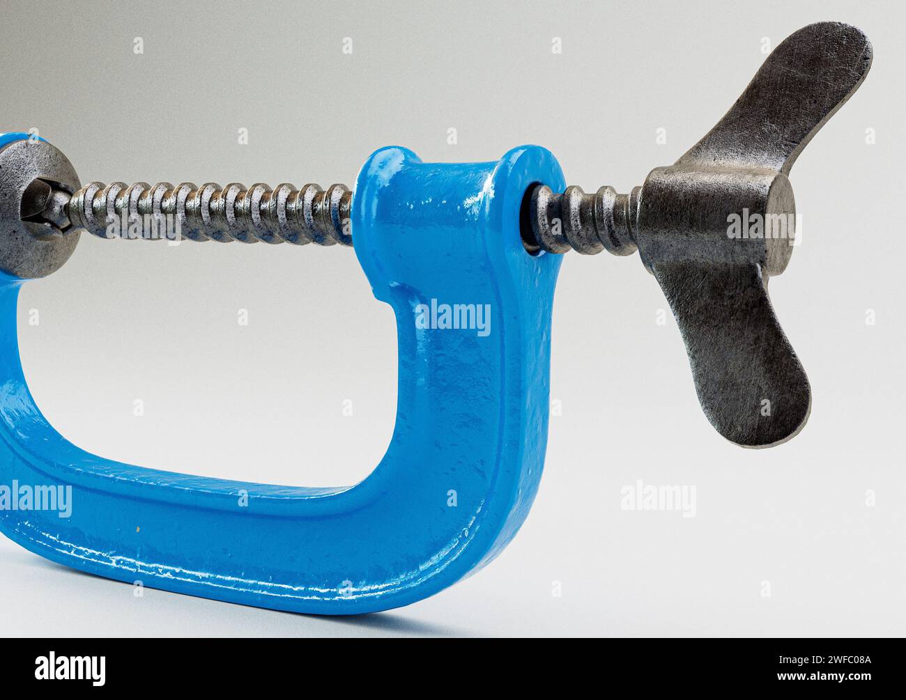 A blue vintage styled G-clamp tool on an isolated white studio ...