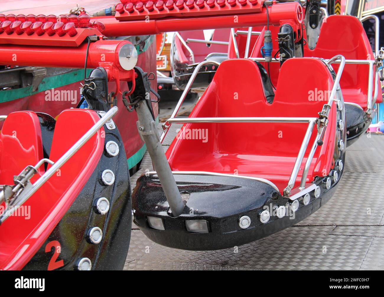 The Bright Red Seats of a Fun Fair Amusement Ride Stock Photo - Alamy