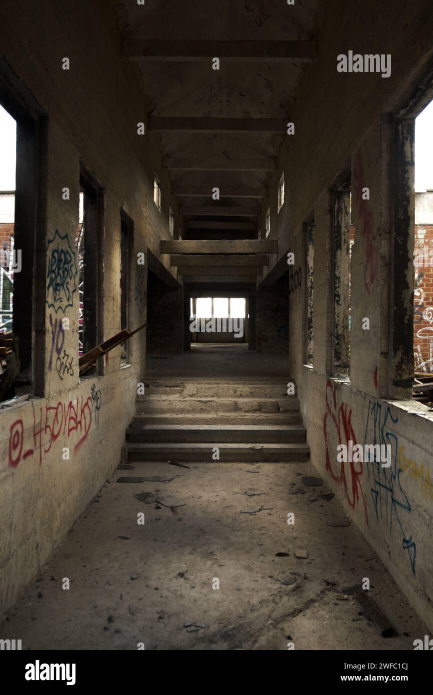 Colorful graffiti covering the walls and floor of an urban abandoned ...
