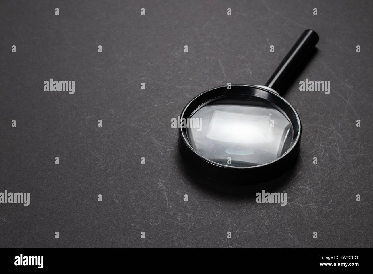 magnifying glass on black texture background with shadow Stock Photo ...