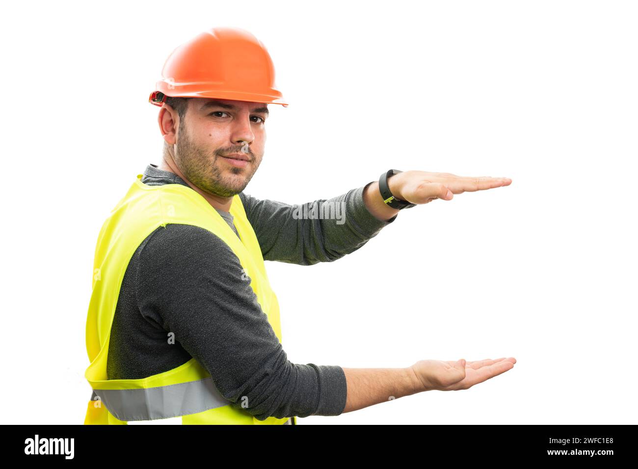 Constructor man with friendly smile wearing orange hardhat and ...