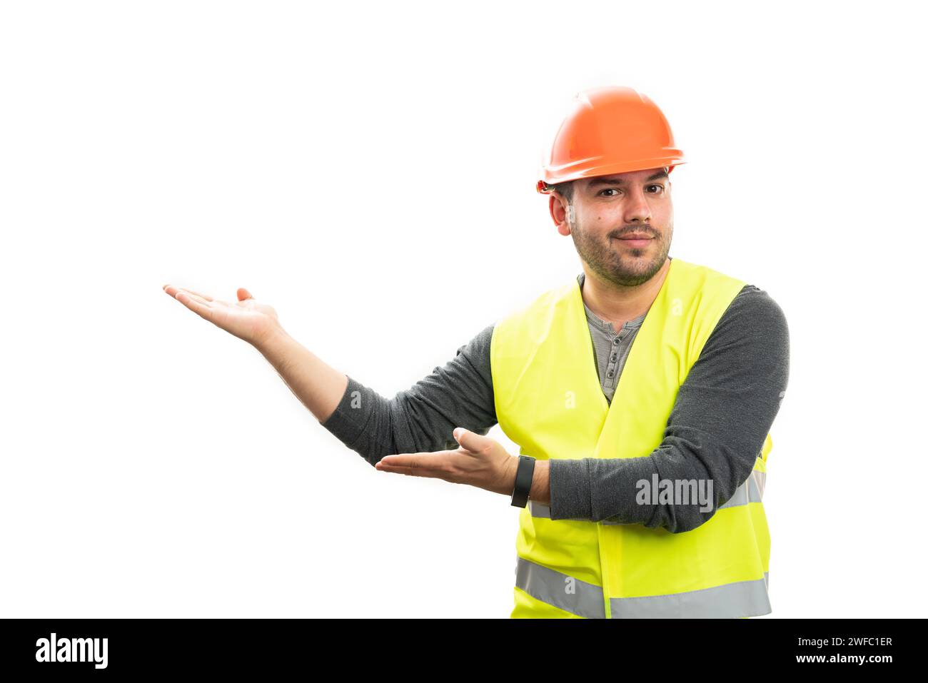 Adult friendly male builder in vest and safety helmet work attire ...