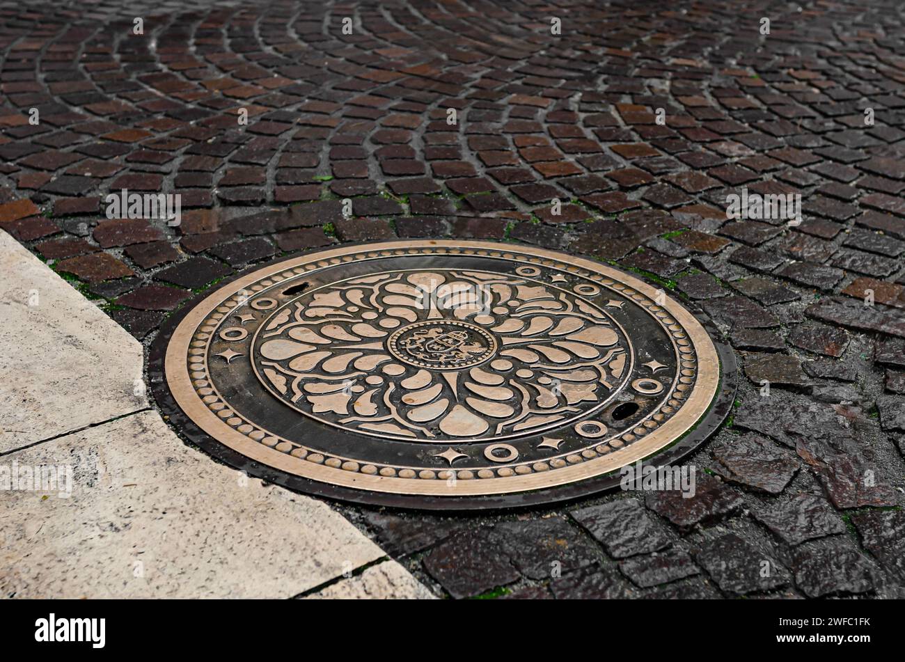Old manhole on the road Stock Photo - Alamy