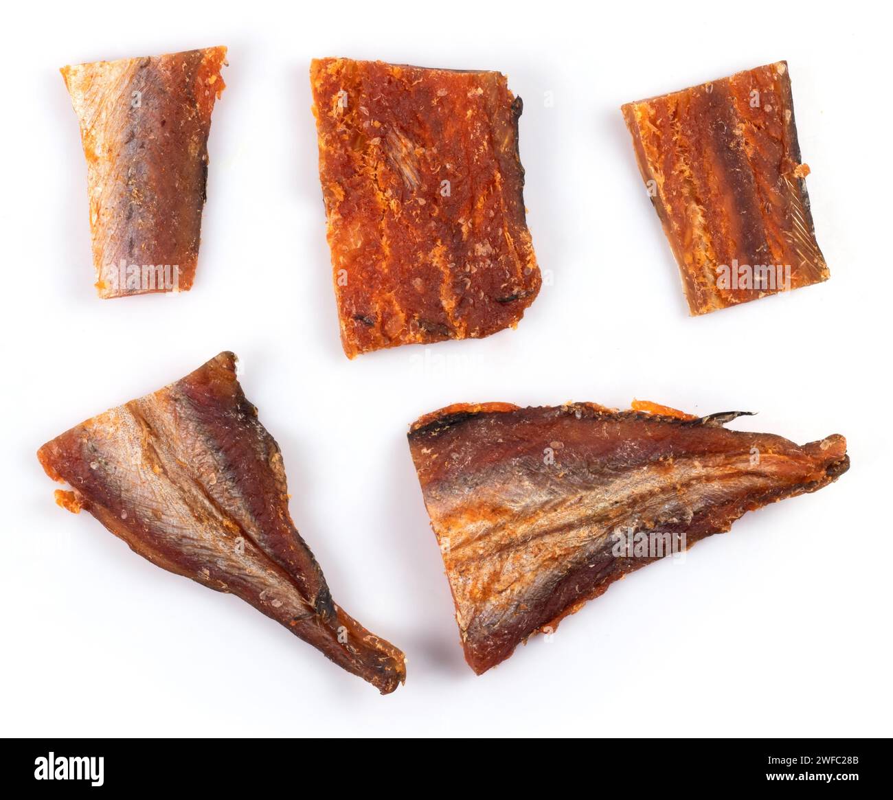 Pieces of cleaned dried fish isolated on white. Dry Peppered Pollack ...