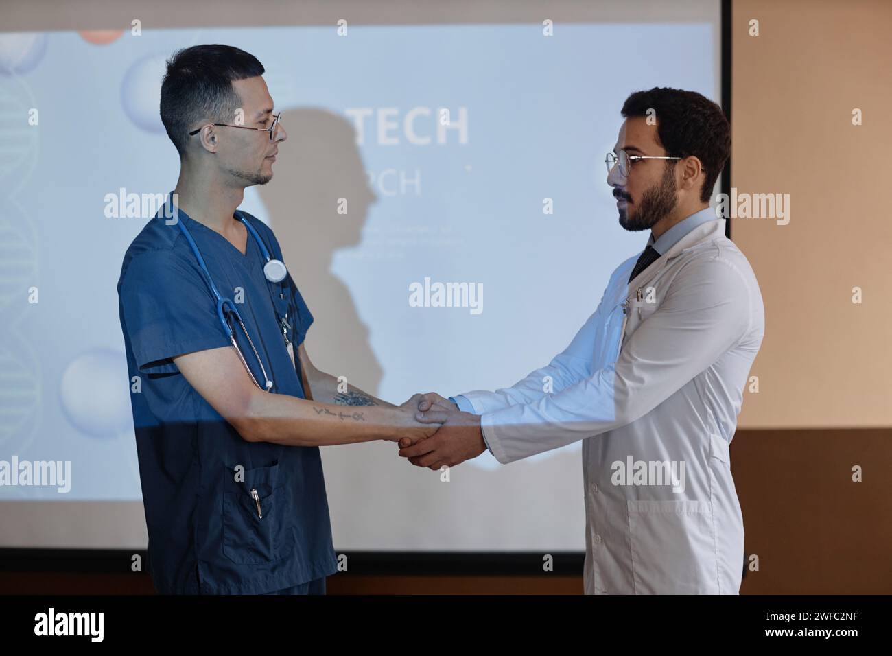 Two young doctors handshake hi-res stock photography and images - Alamy