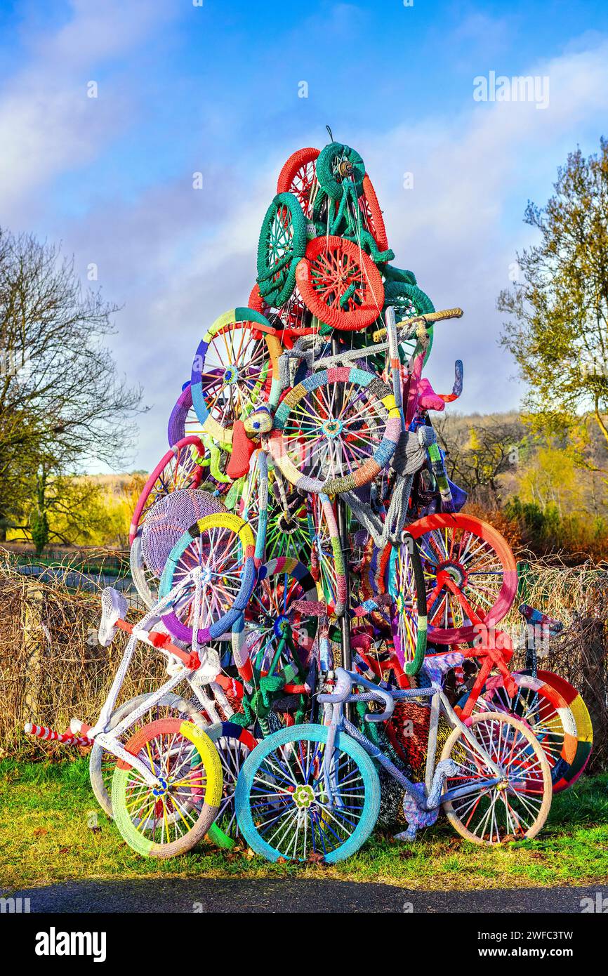 Tall stack of bicycles and wheels covered in knitting and crochet as ...