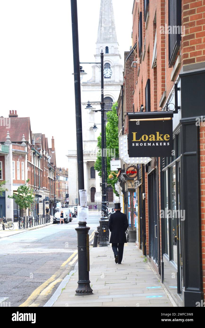 A man in a top hat walking on Brushfield Street, Spitalfields, London ...