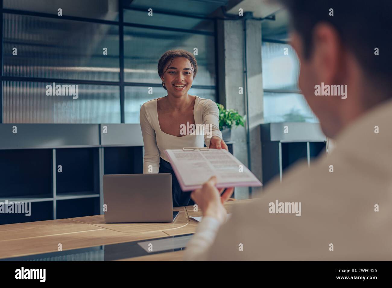 Confident happy female boss giving out paper document report to ...