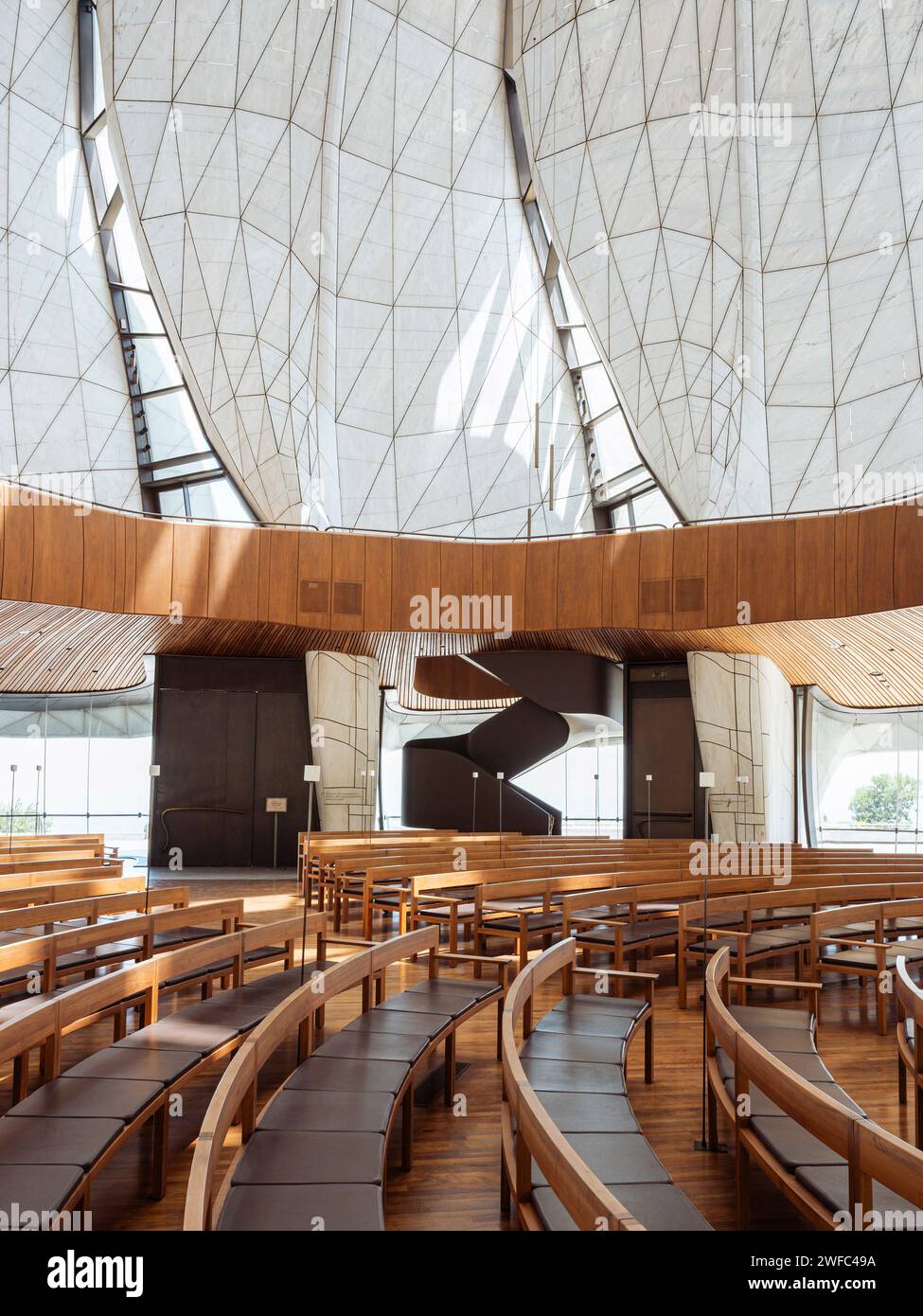 Temple interior with timber benches, balcony, stairway and view of ...