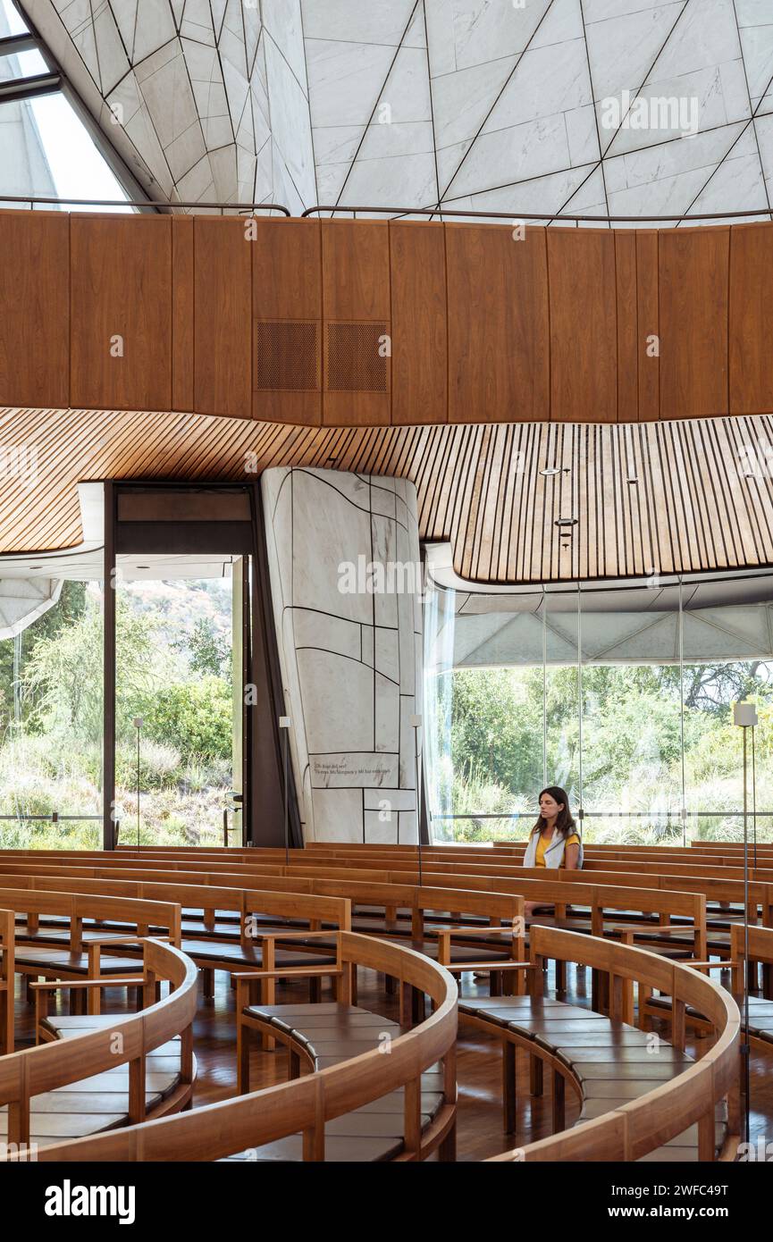 Interior of temple with modern timber benches and visitor. Bahá í ...