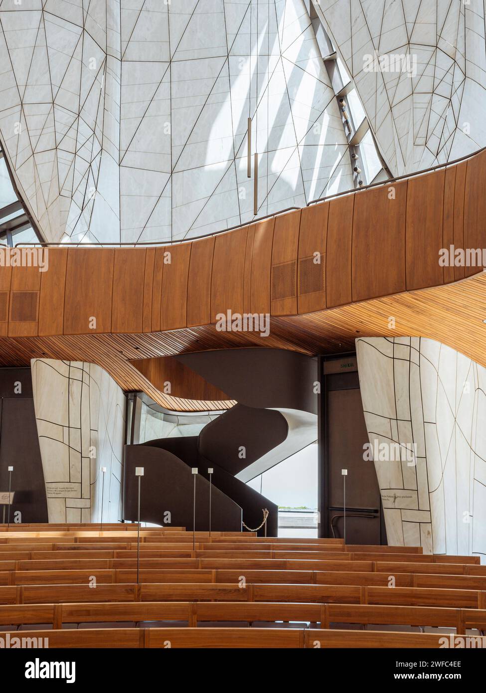 Temple interior with timber benches, balcony, stairway and view of ...