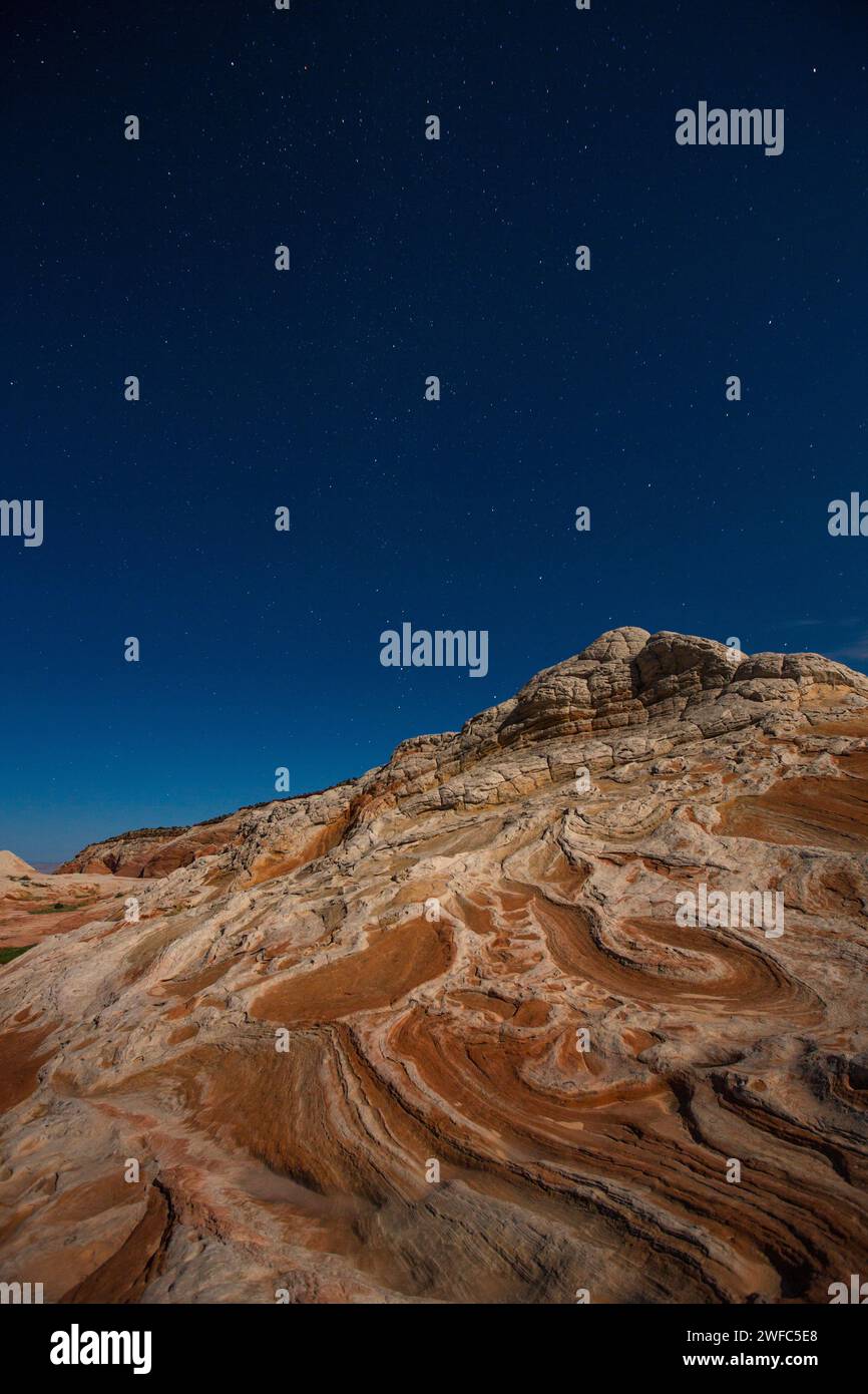Stars over the colorful moonlit sandstone in the White Pocket ...