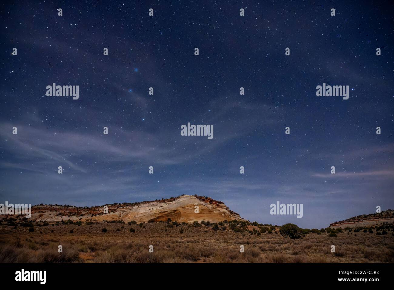 Stars & clouds over a moonlit mesa in the White Pocket Recreation Area ...