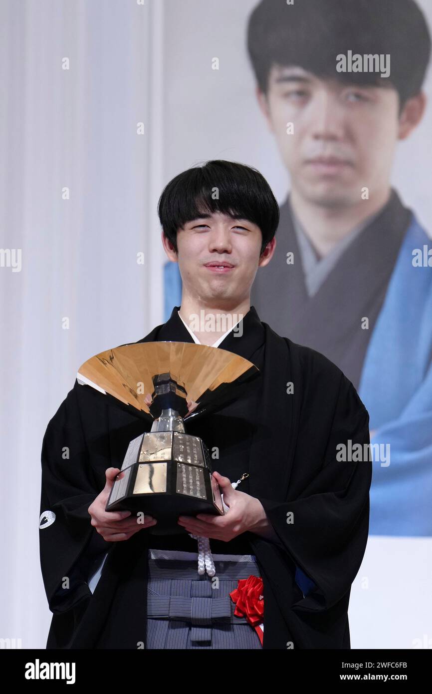 Japanese Shogi player Sota Fujii smiles while holding the Ryuo Cup at ...