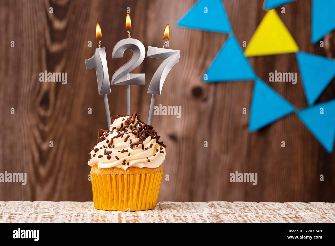 Birthday card with candle number 127 - Wooden background with pennants ...