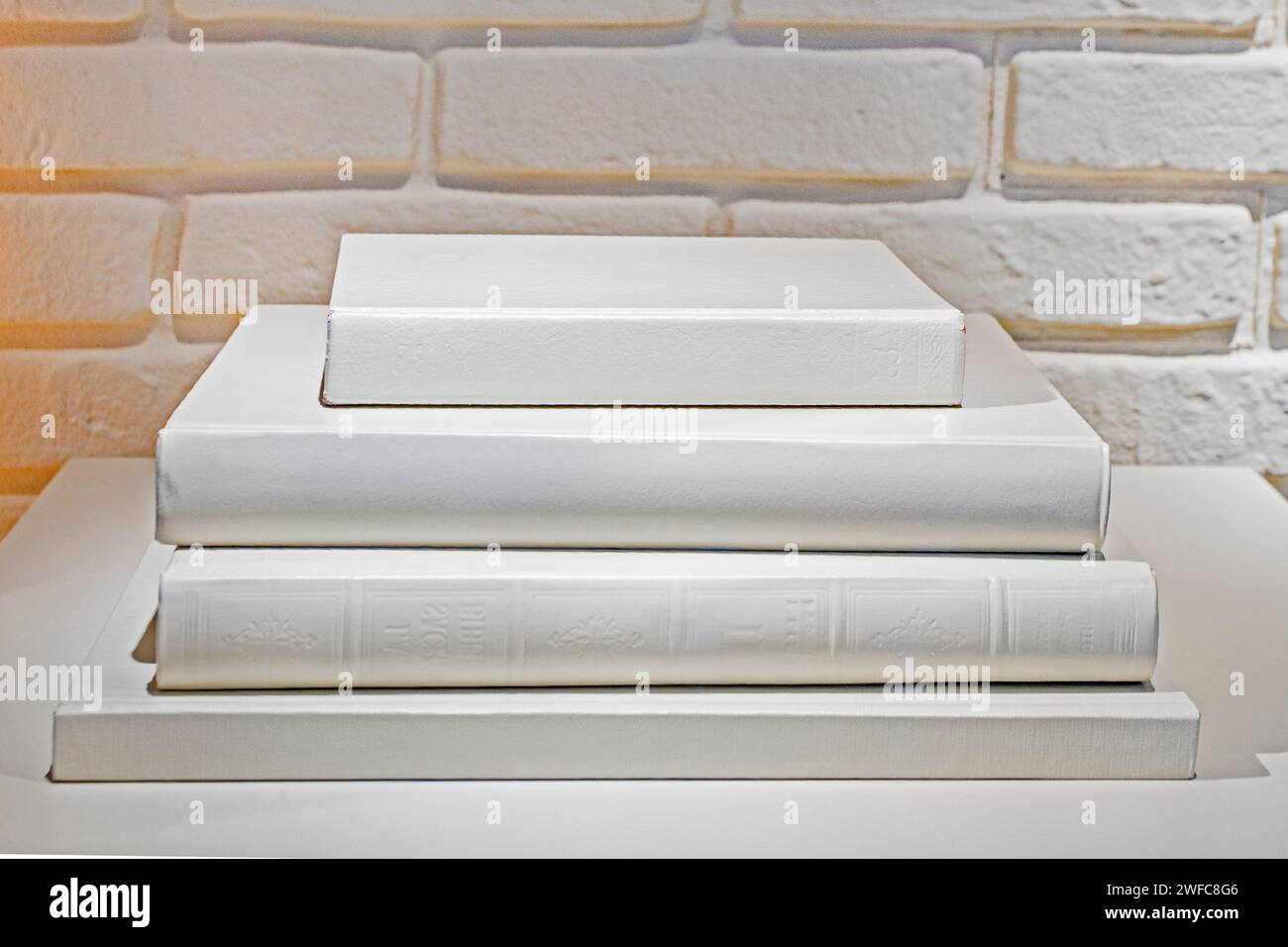 stack of white books on a white wall background. Education and Stock ...