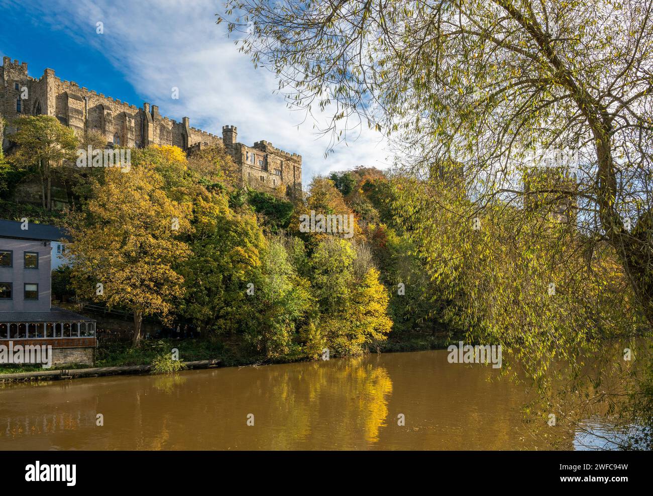 Colourful autumnal woodland and Durham Castle in November on the banks ...